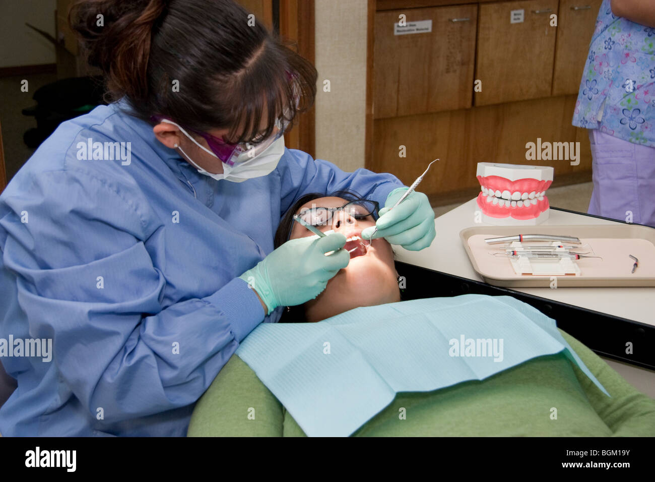Native American dental technician cleans a tribal member patient's ...