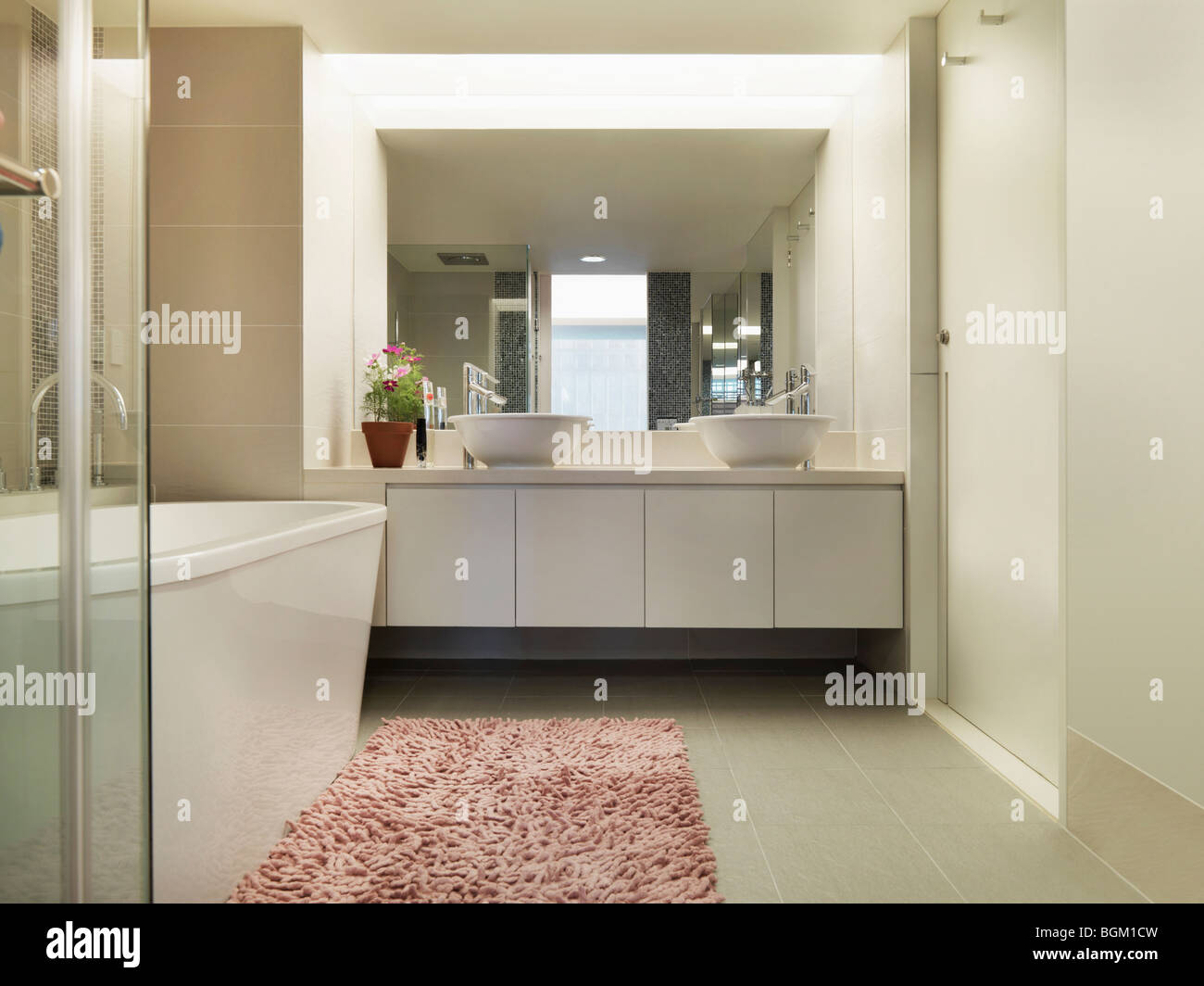 Light colored modern bathroom with large bathtub Stock Photo - Alamy