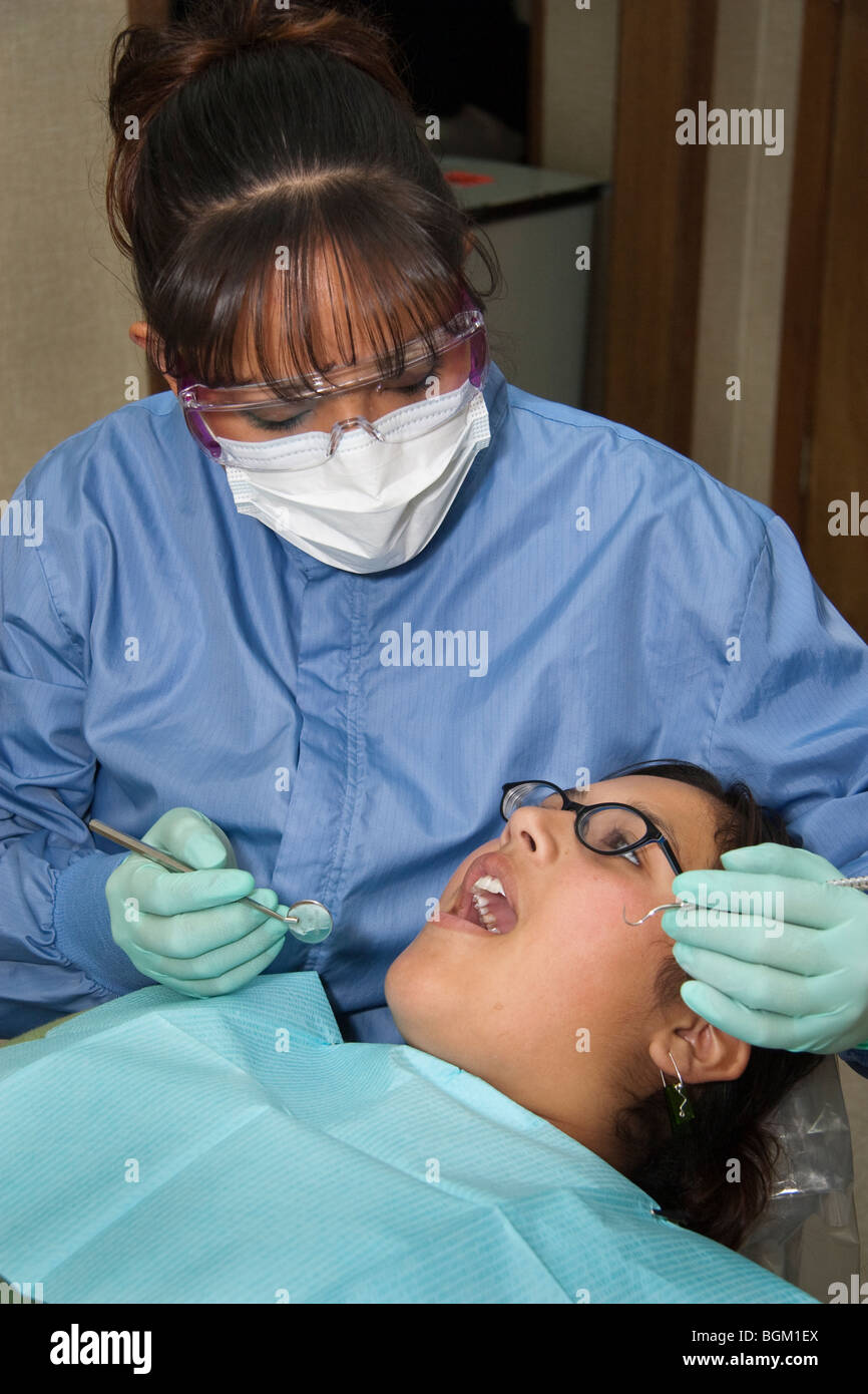 Native American dental technician cleans a tribal member patient's ...