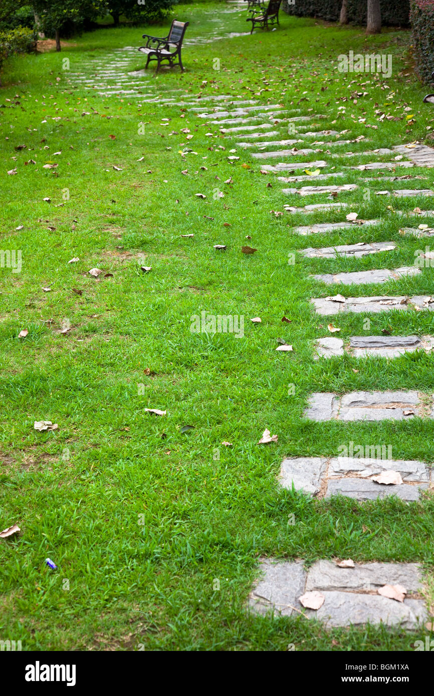 footpath and bench in a garden,with green grass background Stock Photo ...