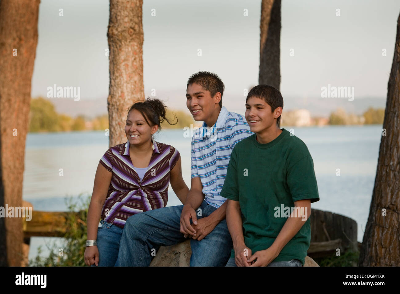 Three Native American teenagers talk while they hang out together on ...