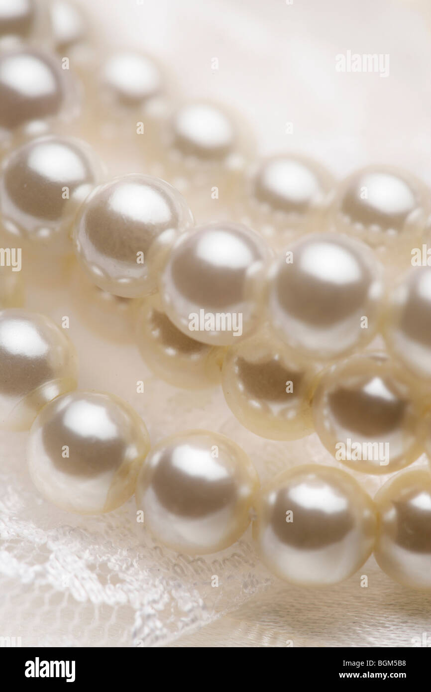 Close up of white pearls and lace Stock Photo - Alamy