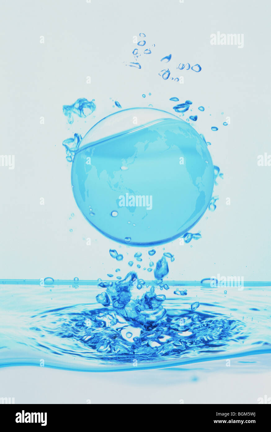 Sphere and drops of water above surface Stock Photo - Alamy