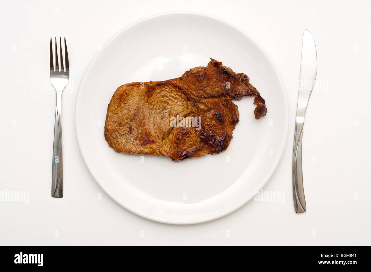 Juicy stake on a plate, isolated white background Stock Photo - Alamy