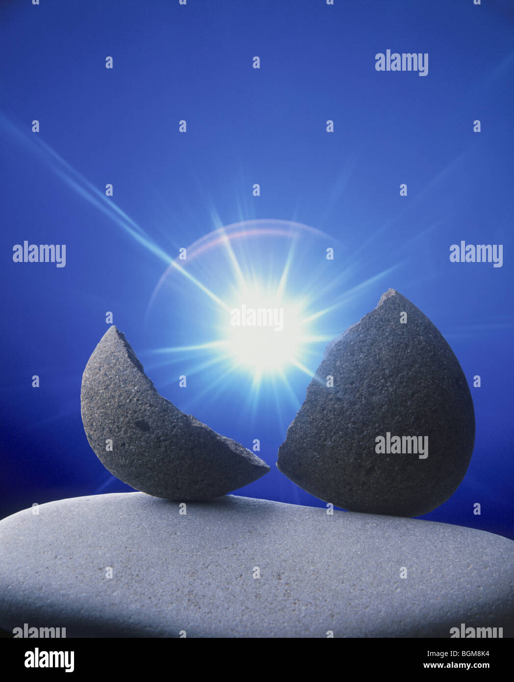 Sun shining through a stone cracked in half Stock Photo - Alamy