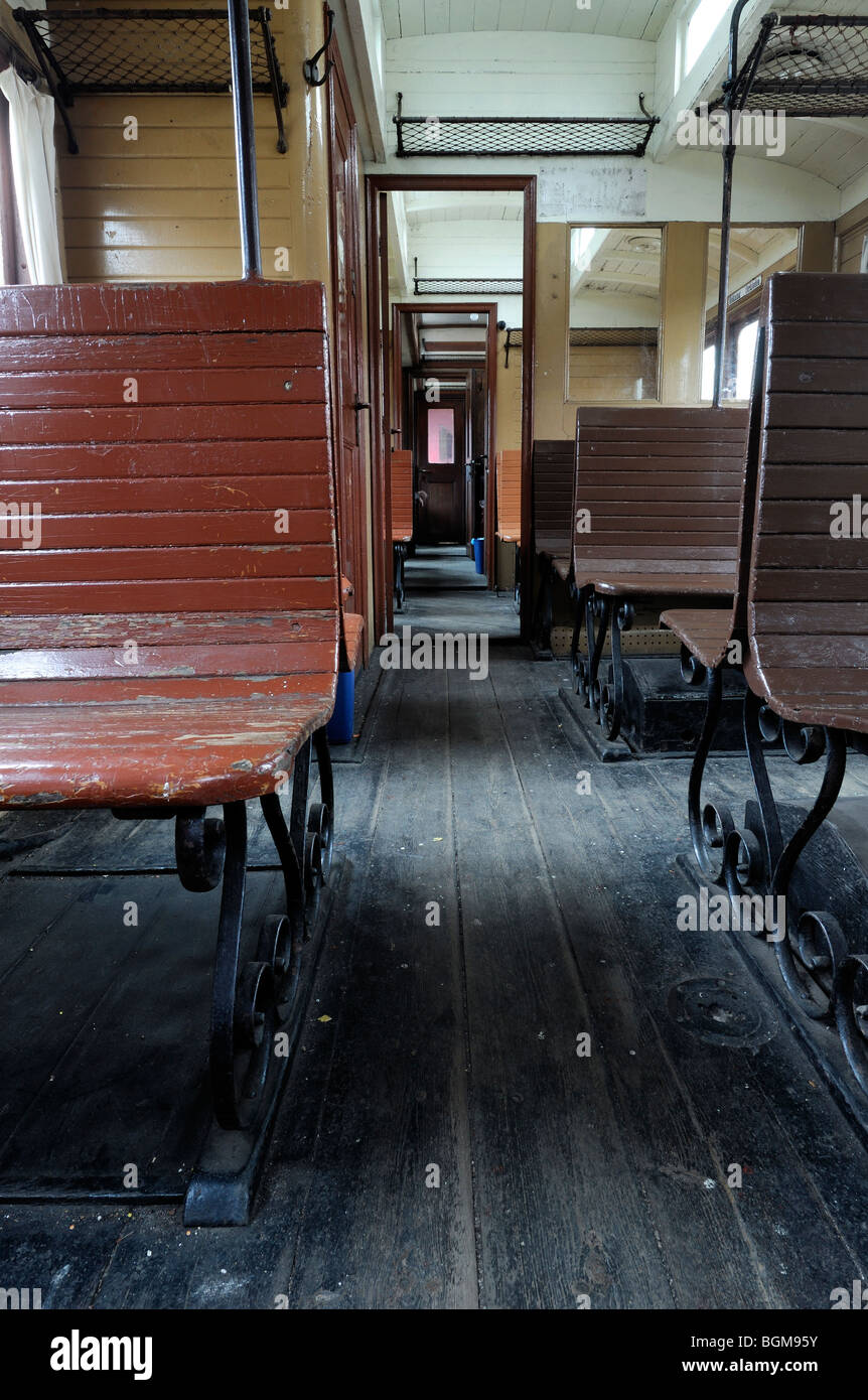 An old fashioned looking passenger carriage in a train hauled by a ...