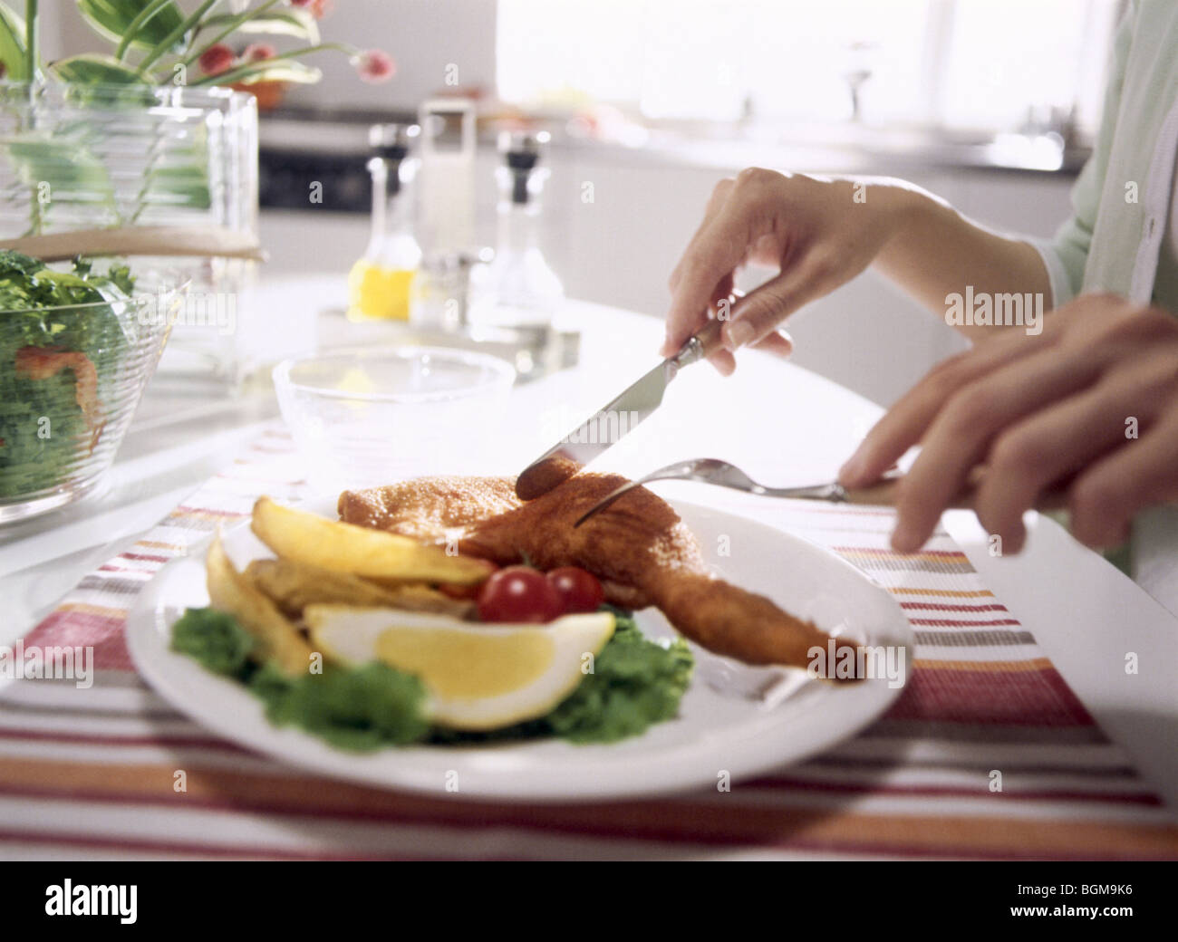 Person eating meal at table Stock Photo - Alamy