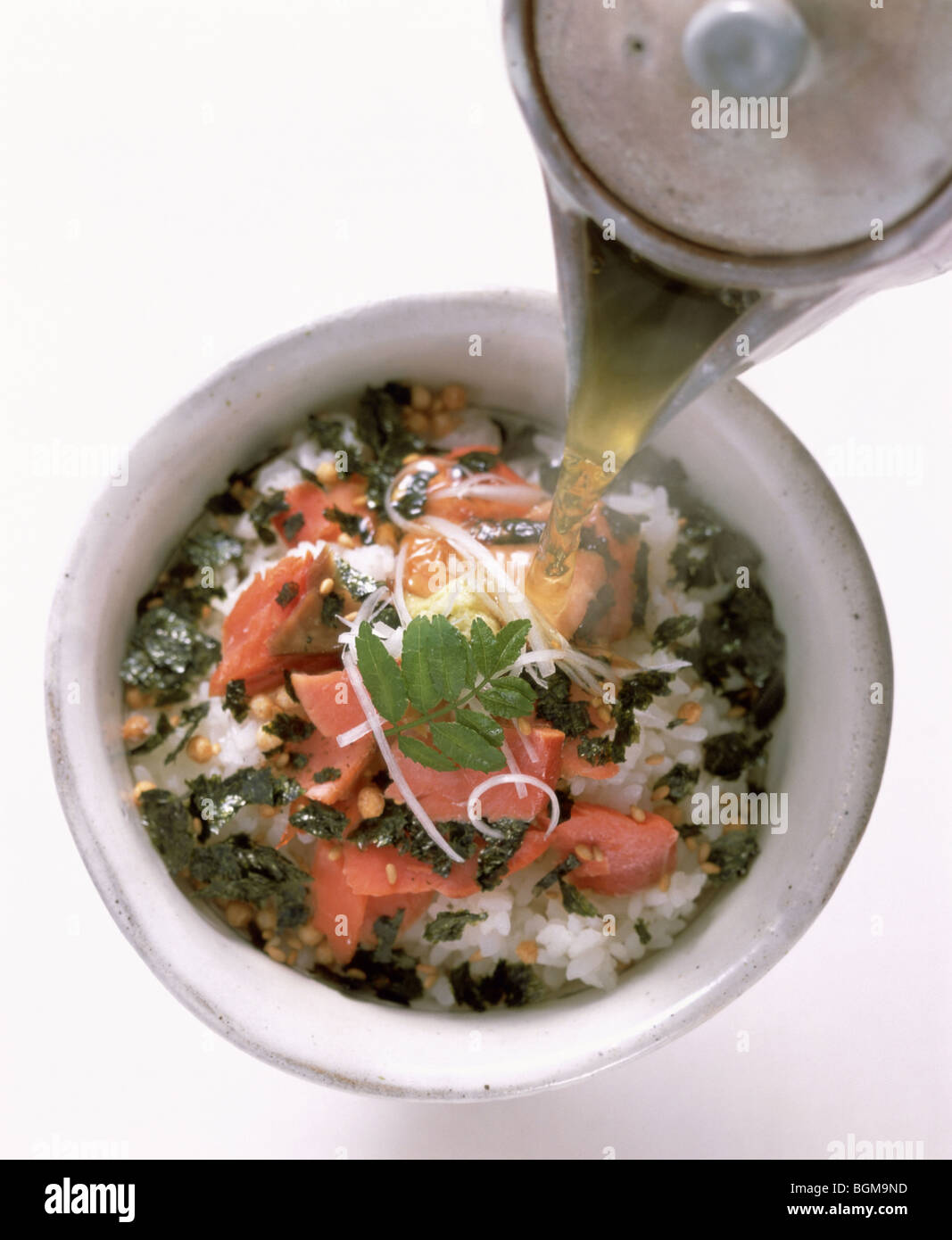 Tea being poured onto rice dish Stock Photo - Alamy