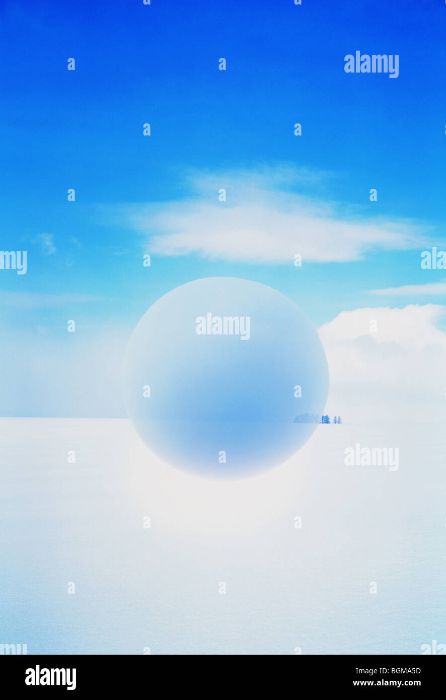Sphere floating over snowy landscape Stock Photo - Alamy