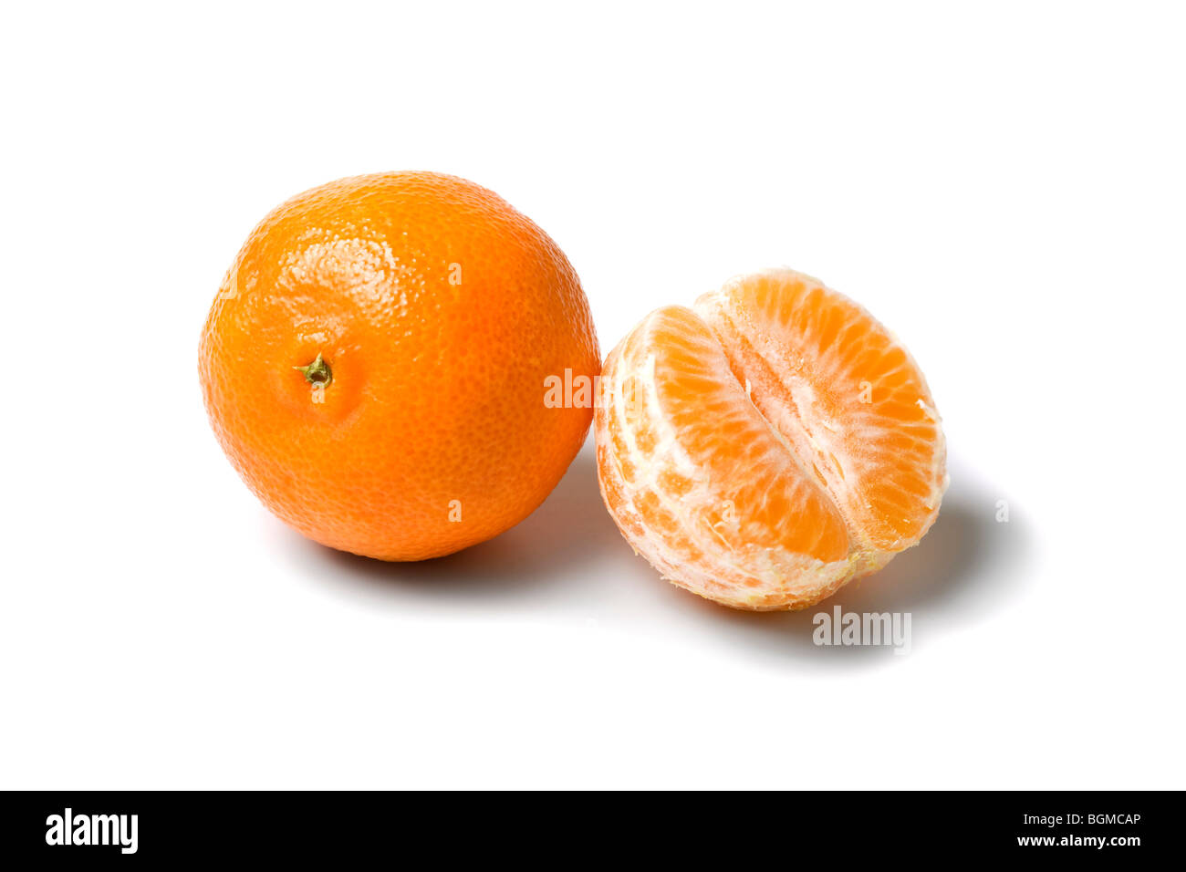 a whole and a half tangerine isolated on white Stock Photo - Alamy