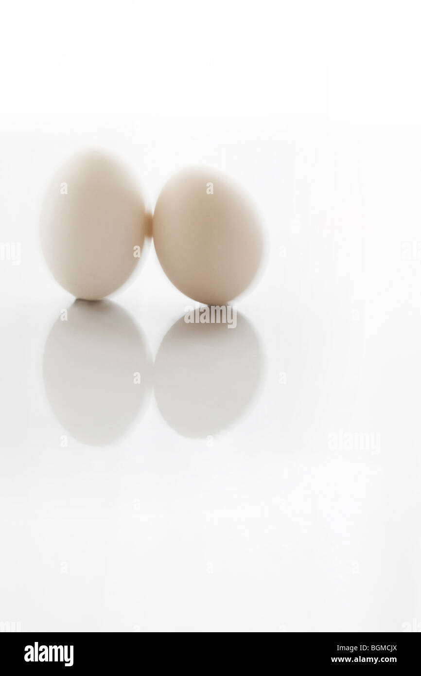 Two eggs leaning on one another Stock Photo - Alamy
