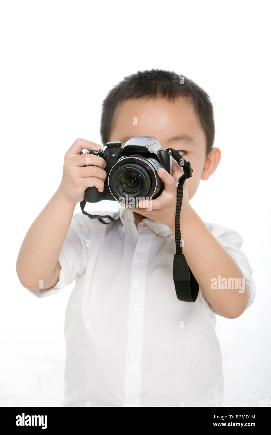 Little boy taking photo by digital camera Stock Photo - Alamy