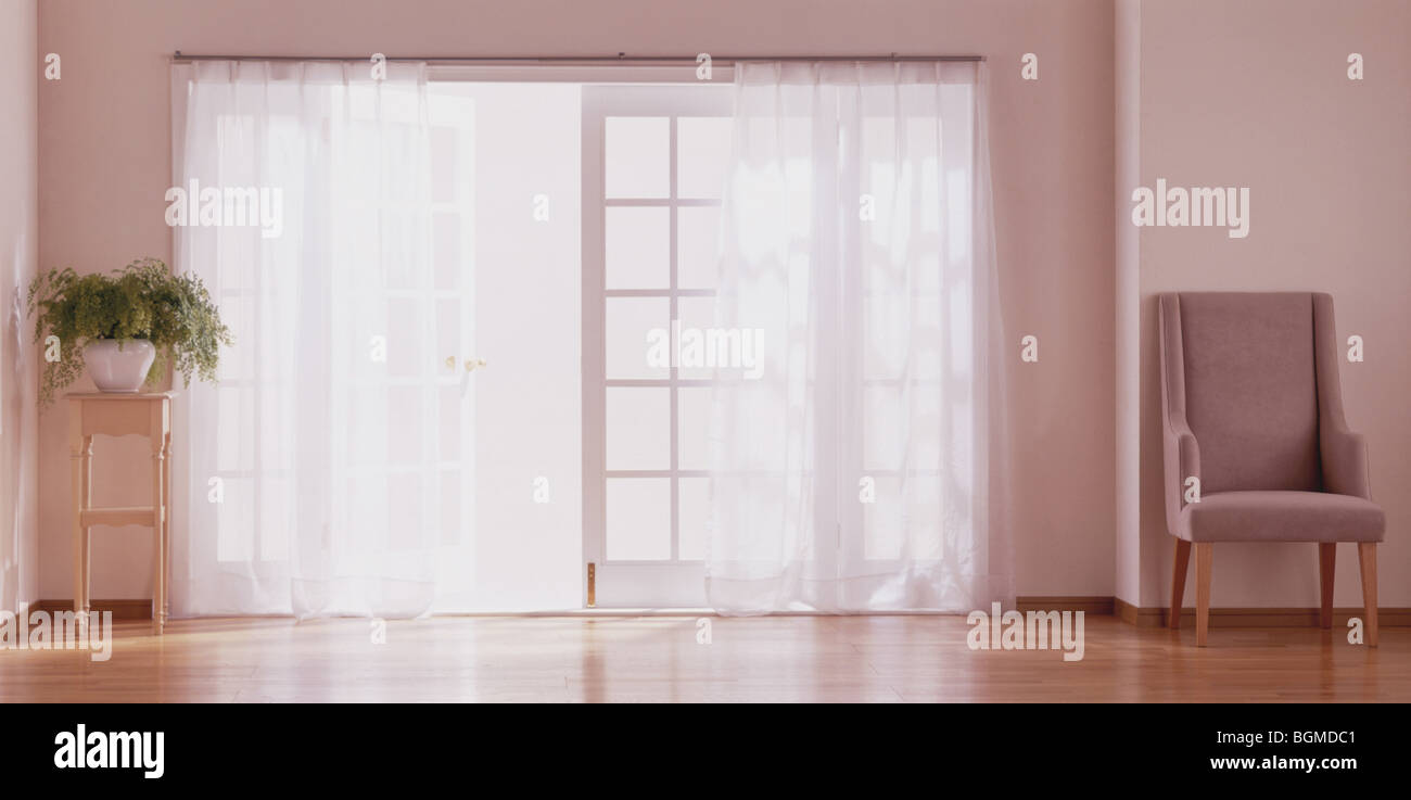 Chair beside window in pink tinted room Stock Photo - Alamy