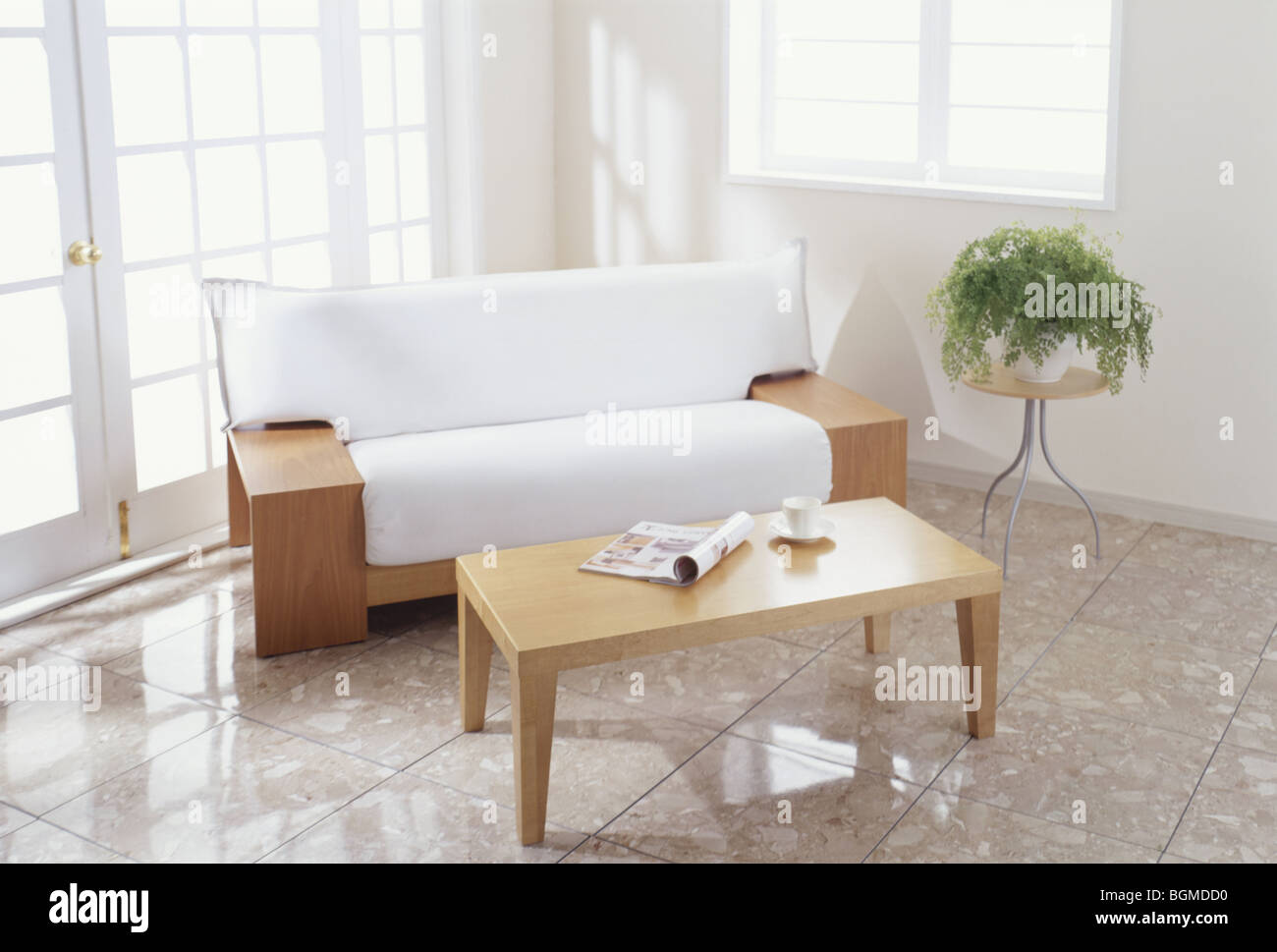 Sofa and coffee table in light room Stock Photo - Alamy