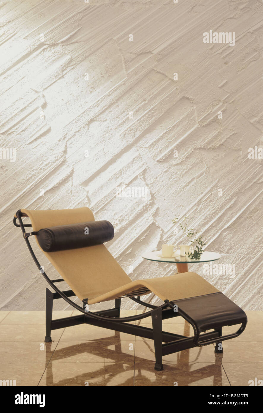 Modern reclining chair with glass side table Stock Photo - Alamy