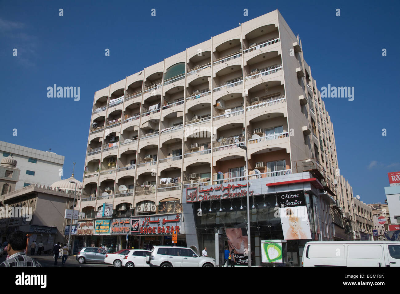 Dubai United Arab Emirates High rise apartment block with shops around ...