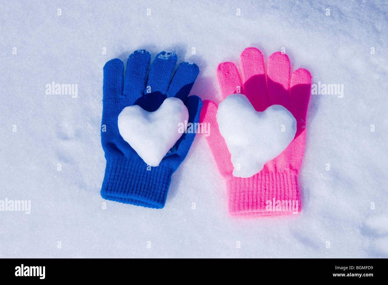 Mittens on the Snow with Lovehearts Stock Photo - Alamy