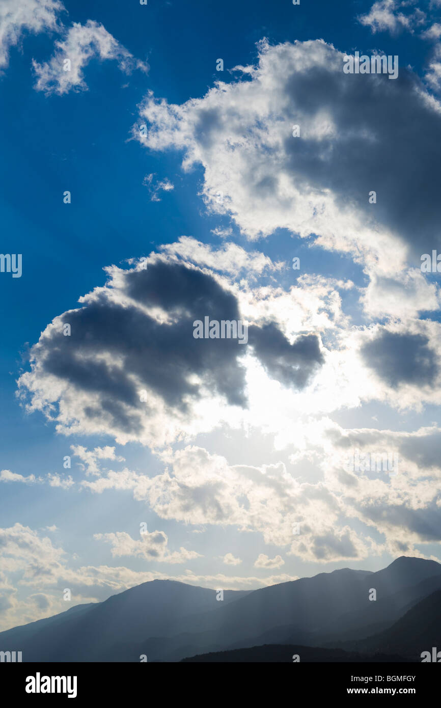 Sunlight streaming through clouds Stock Photo - Alamy