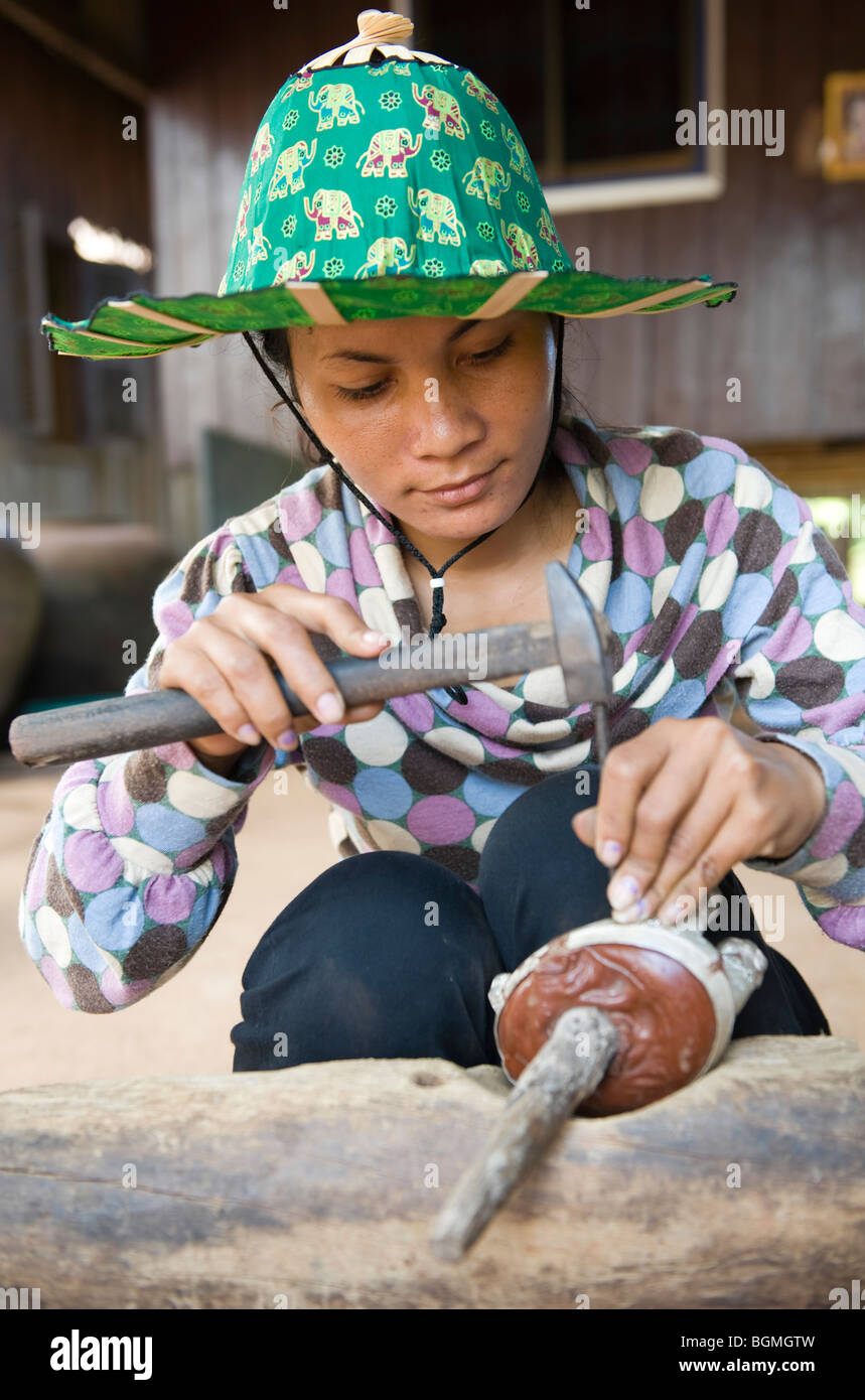 A silver worker silversmith outside the capital of Phnom Penh in ...