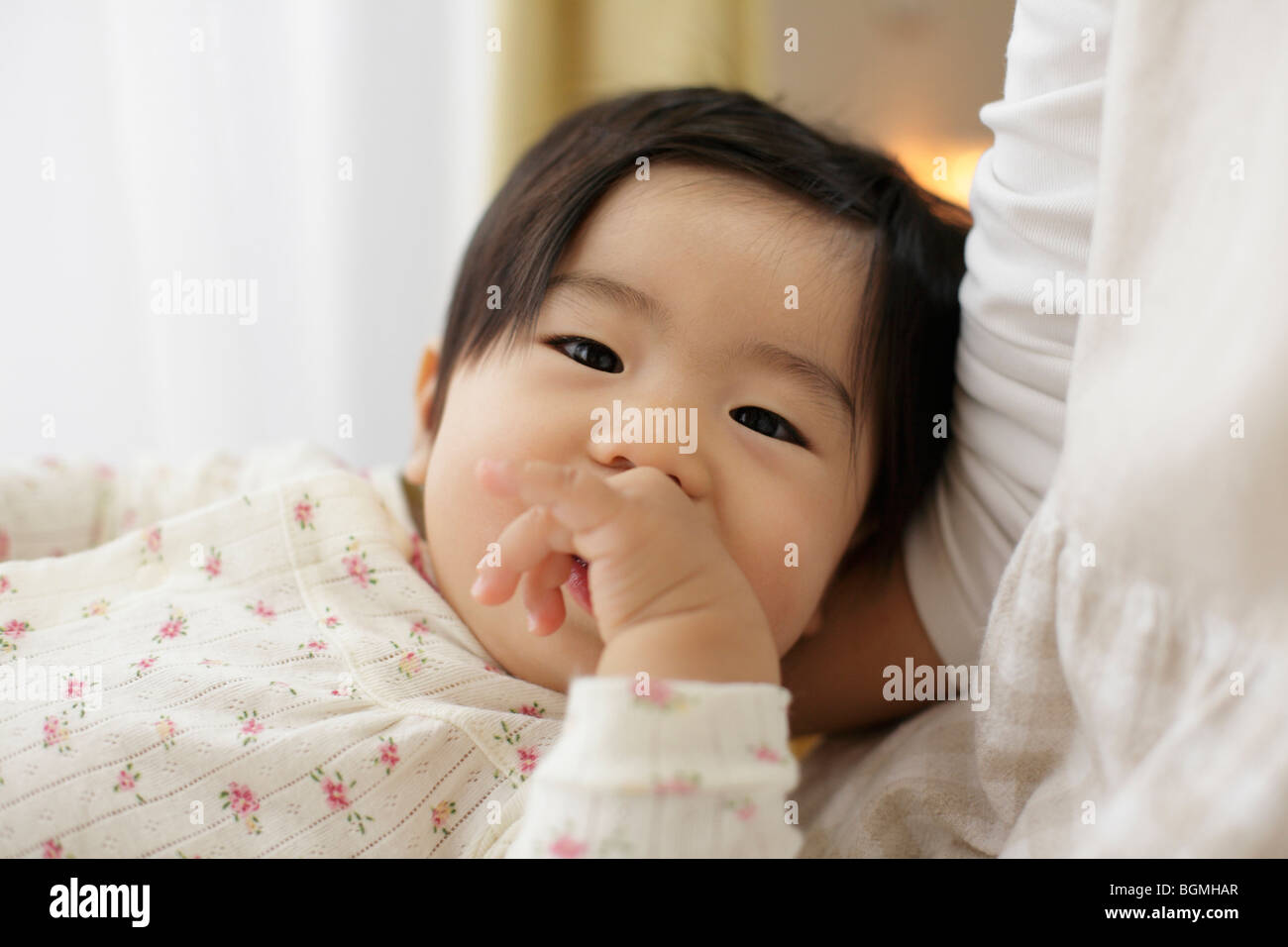 Baby resting on mother Stock Photo - Alamy