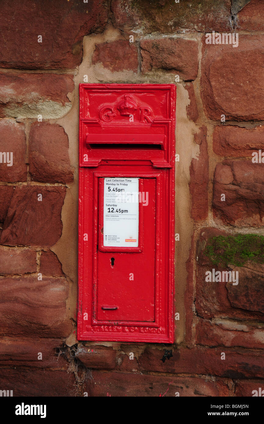 Red post box built into a stone wall Stock Photo - Alamy