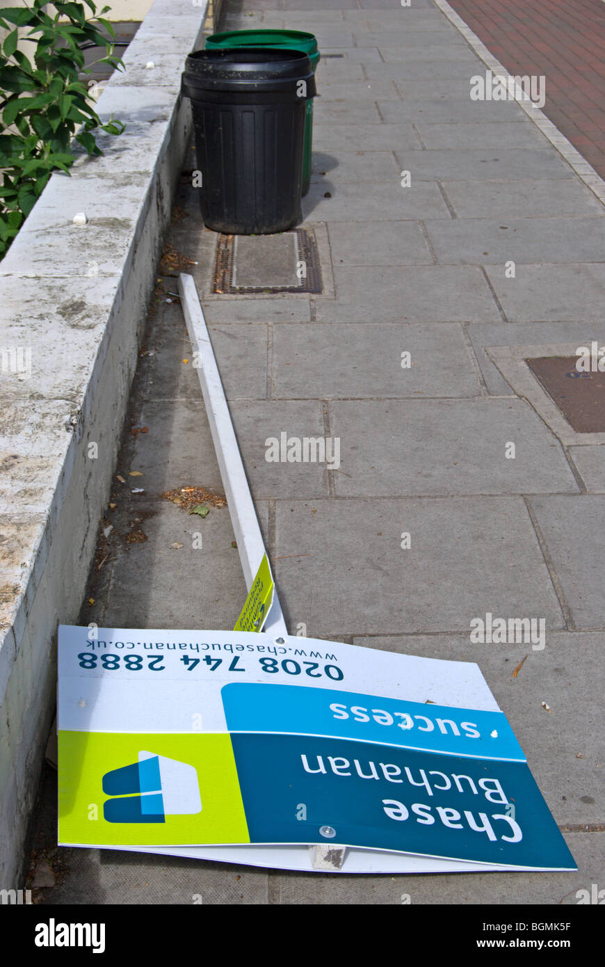 discarded estate agents sign lying on a pavement Stock Photo - Alamy