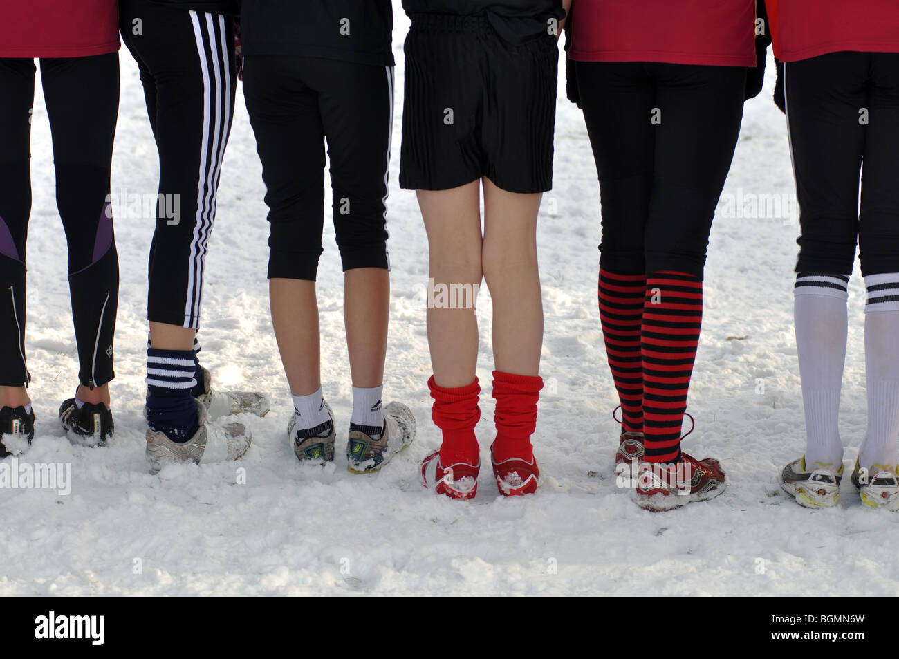 Teenage girls on start line of cross-country running race standing in ...