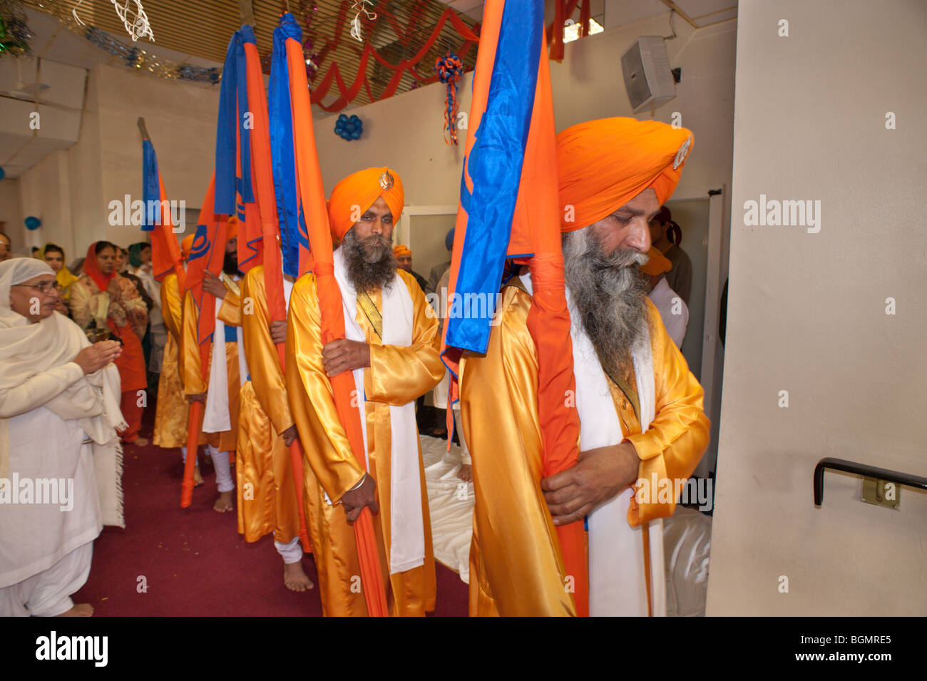 Khalsa carrying Nisan Sahib (Sikh flags) process out of worship hall in ...