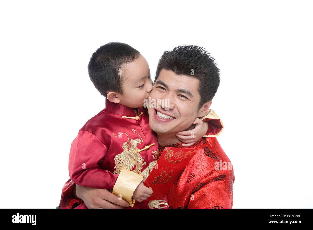 Father and son in Chinese traditional clothes holding red envelope ...