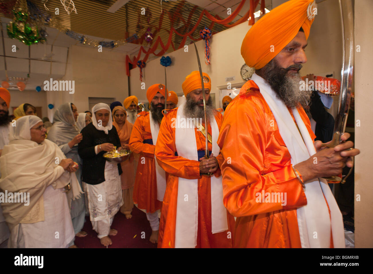 Panj Pyare with kirpan raised process from worship hall at start of ...