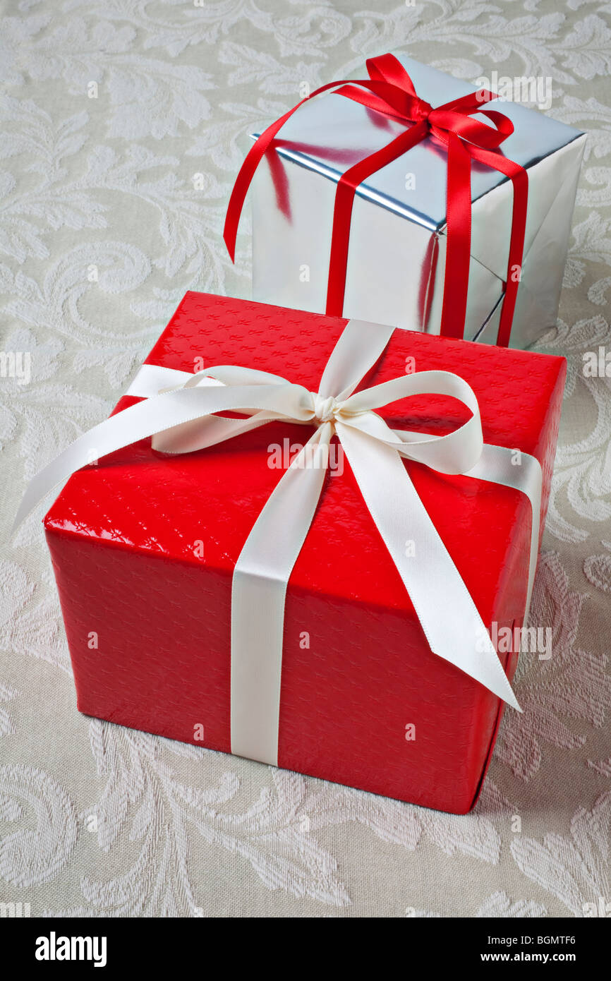 Two gift boxes red and silver Stock Photo - Alamy