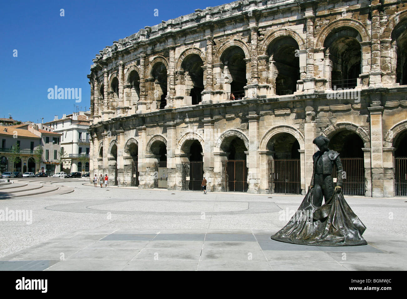 Statue of matador and ancient Roman empire amphitheatre, Nimes ...