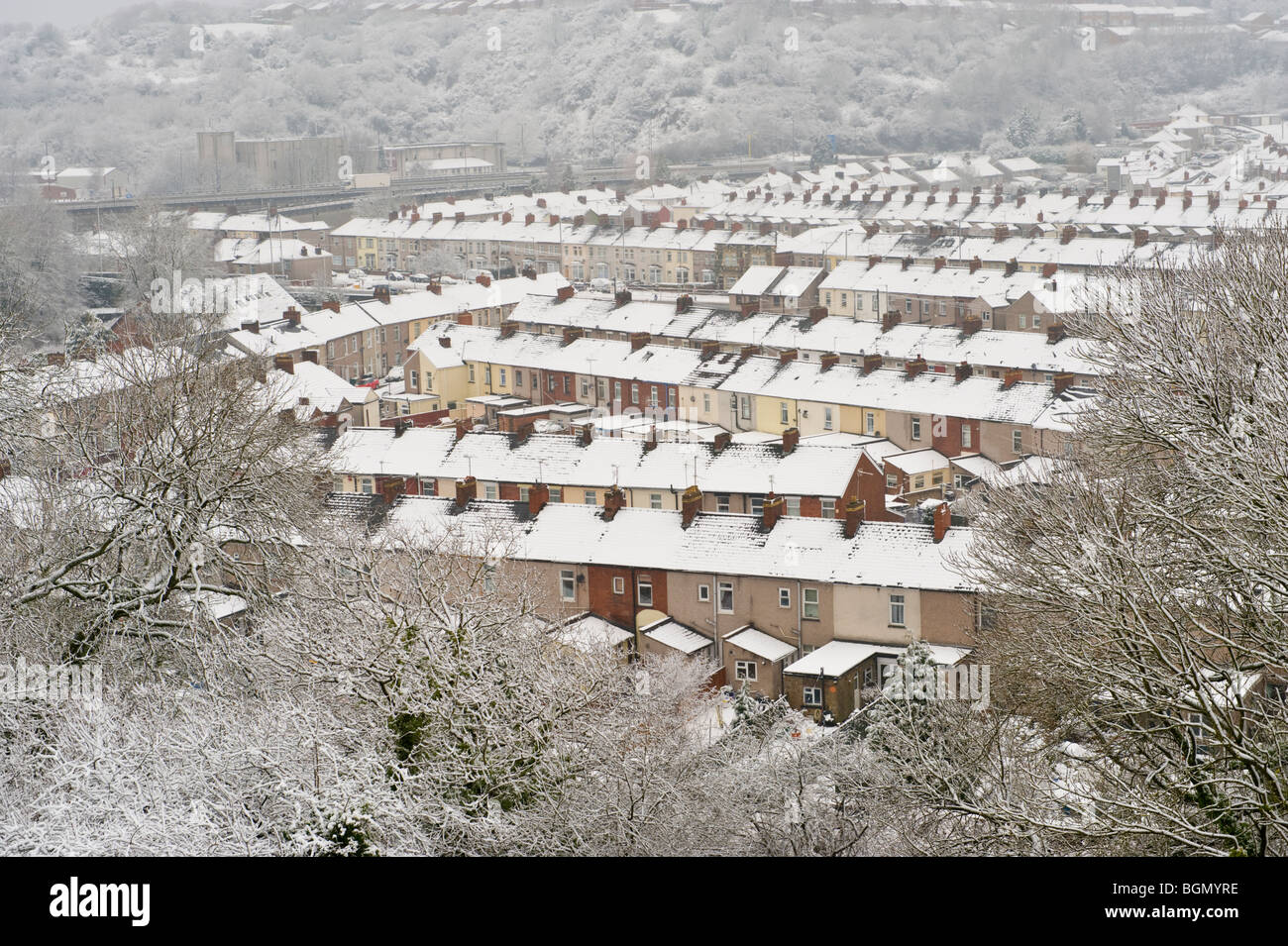 View over rooftops of terraced houses covered in snow at Newport South ...