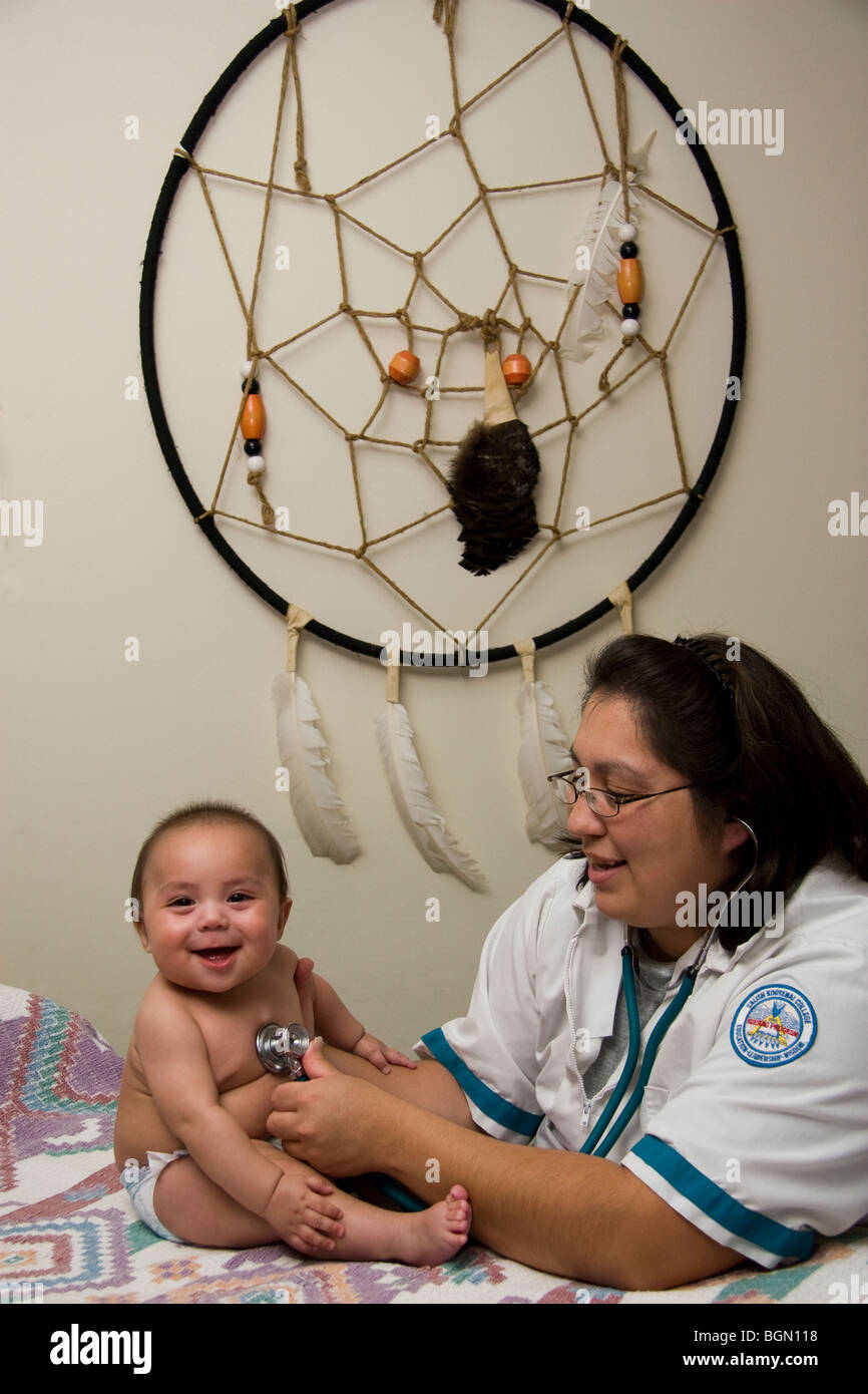 Laughing baby with nurse during a visit to a Native American health ...