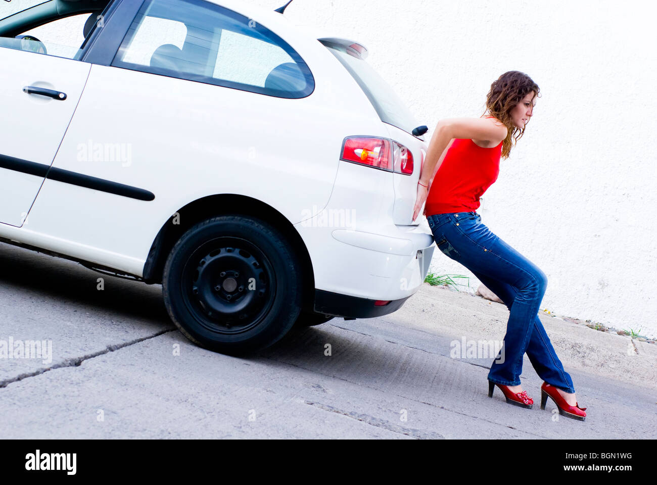 woman pushing car out of gasoline Stock Photo - Alamy
