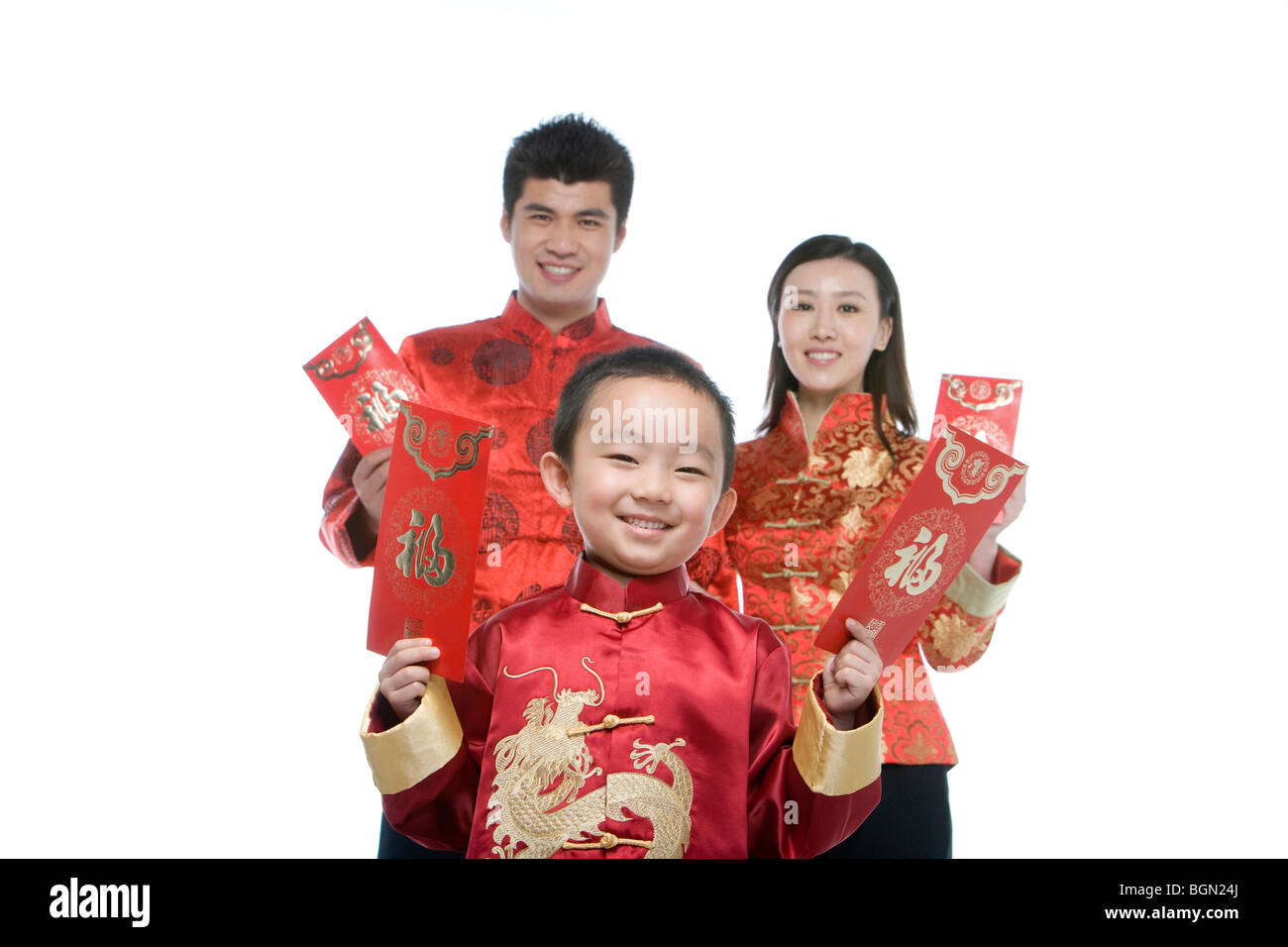Family of three in Chinese traditional clothes holding red envelopes ...