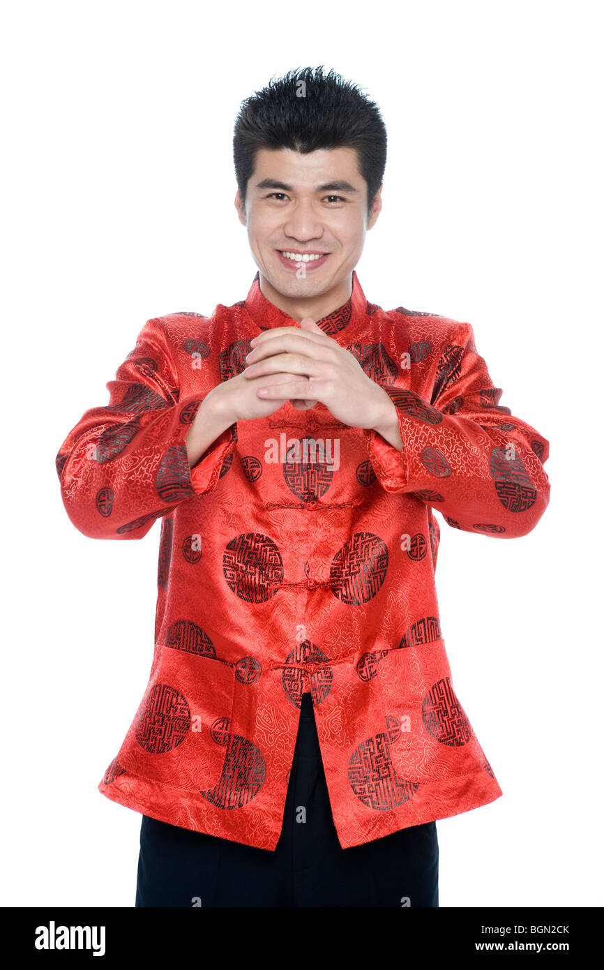 Young man in Chinese traditional clothes giving best wishes Stock Photo ...