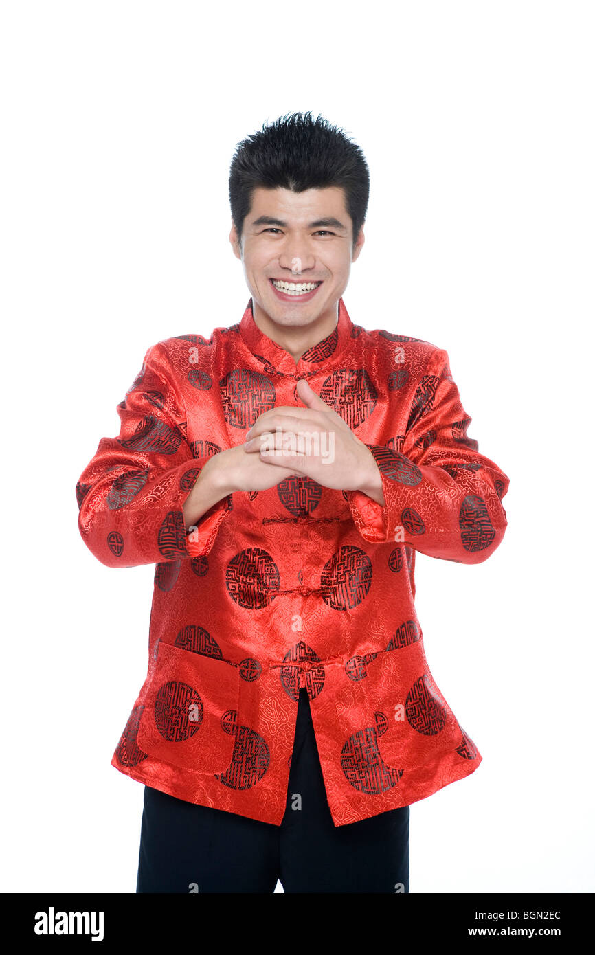 Young man in Chinese traditional clothes giving best wishes Stock Photo ...