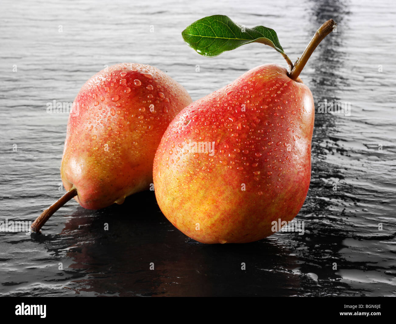 Fresh Red Williams pears whole and cut with leaves Stock Photo - Alamy