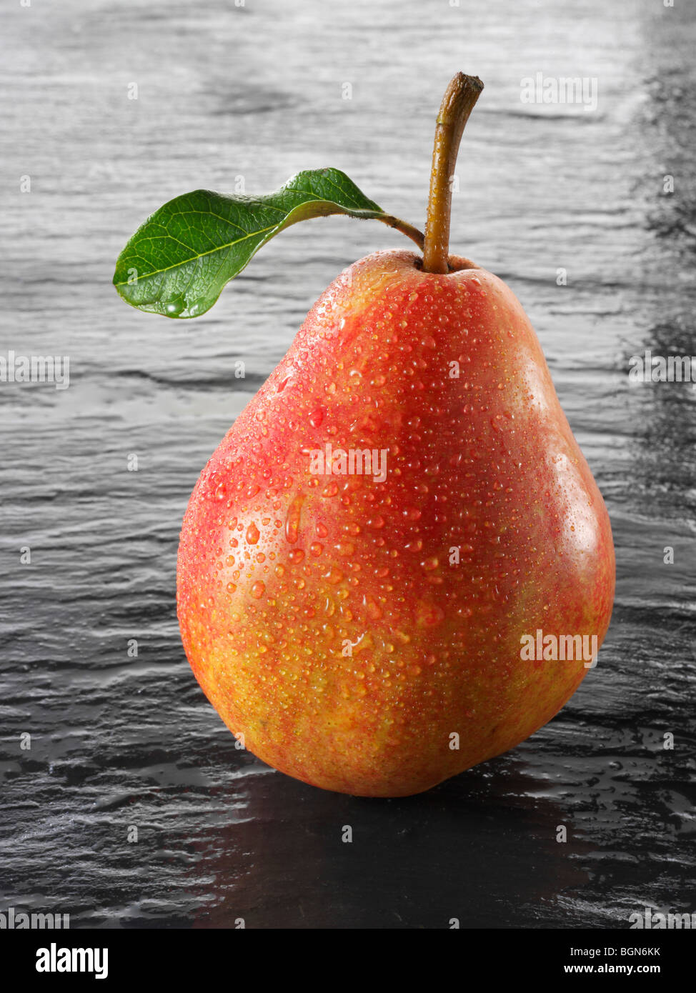 Fresh Red Williams pears whole and cut with leaves Stock Photo - Alamy