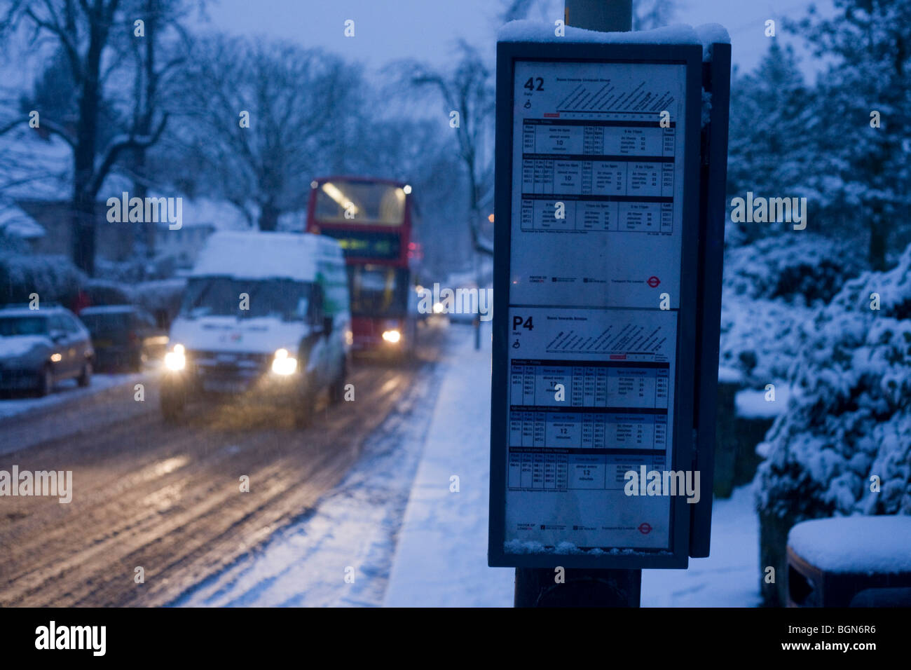 Early morning bus on a snowy hill after fresh snow fall, negotiate ...