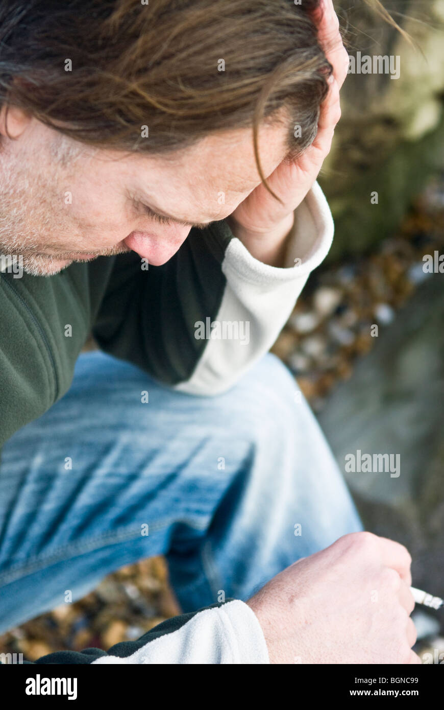 A colour portrait photo of a depressed and stressed mature man smoking ...