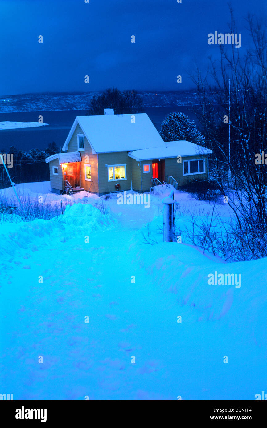Evening lights from snowbound home on long winter night on Lofoten ...