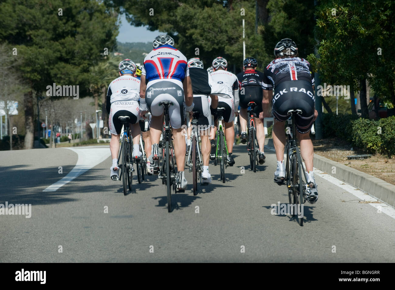 Group of cyclists cycling along a road in Palma, Mallorca, Majorca ...