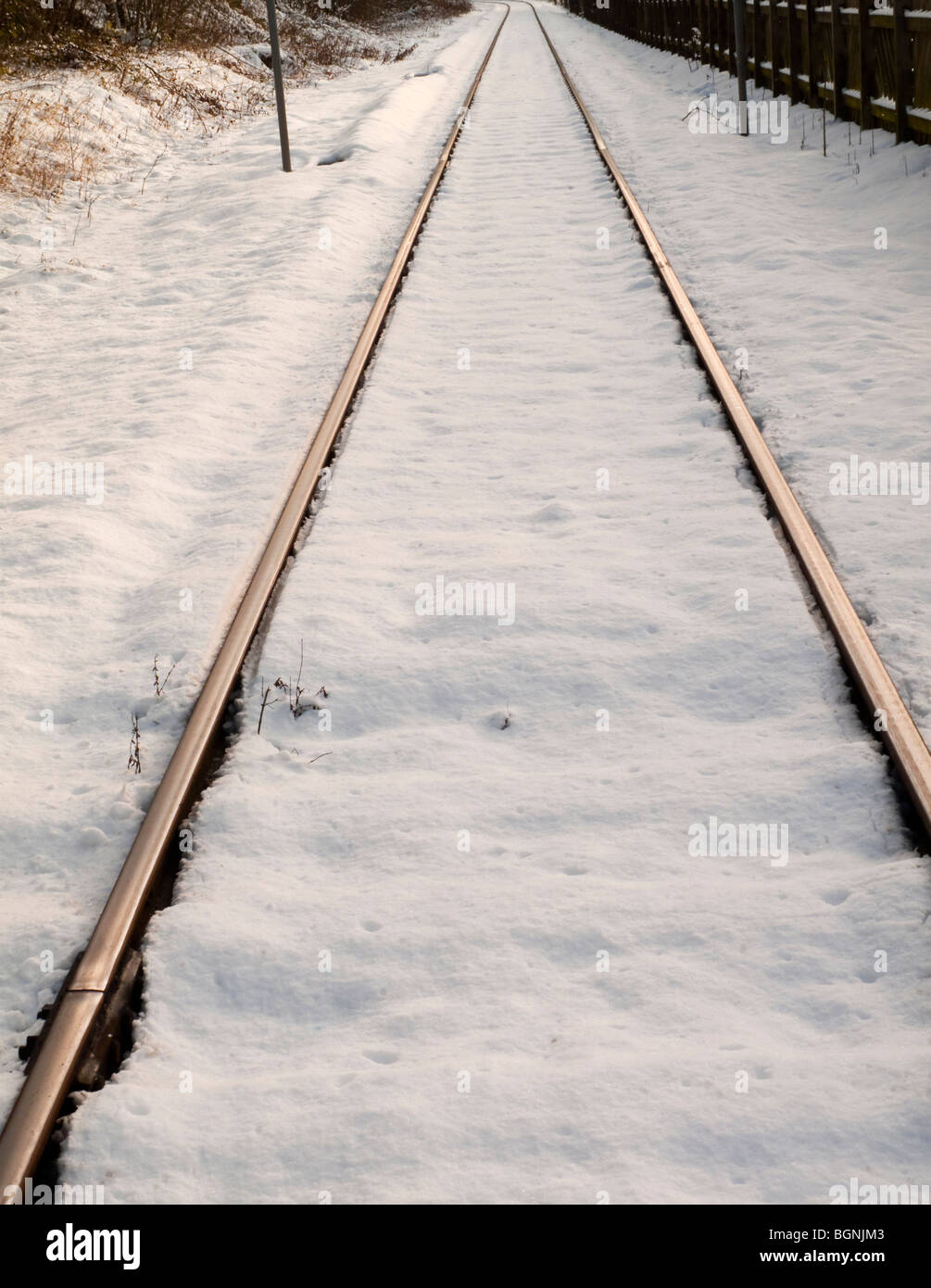 Single track railway line covered in snow with the rails visible Stock ...
