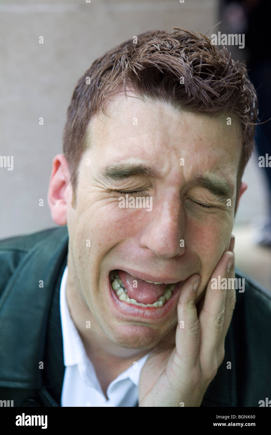 Young guy with crazy expression screaming. Processed to improve the ...