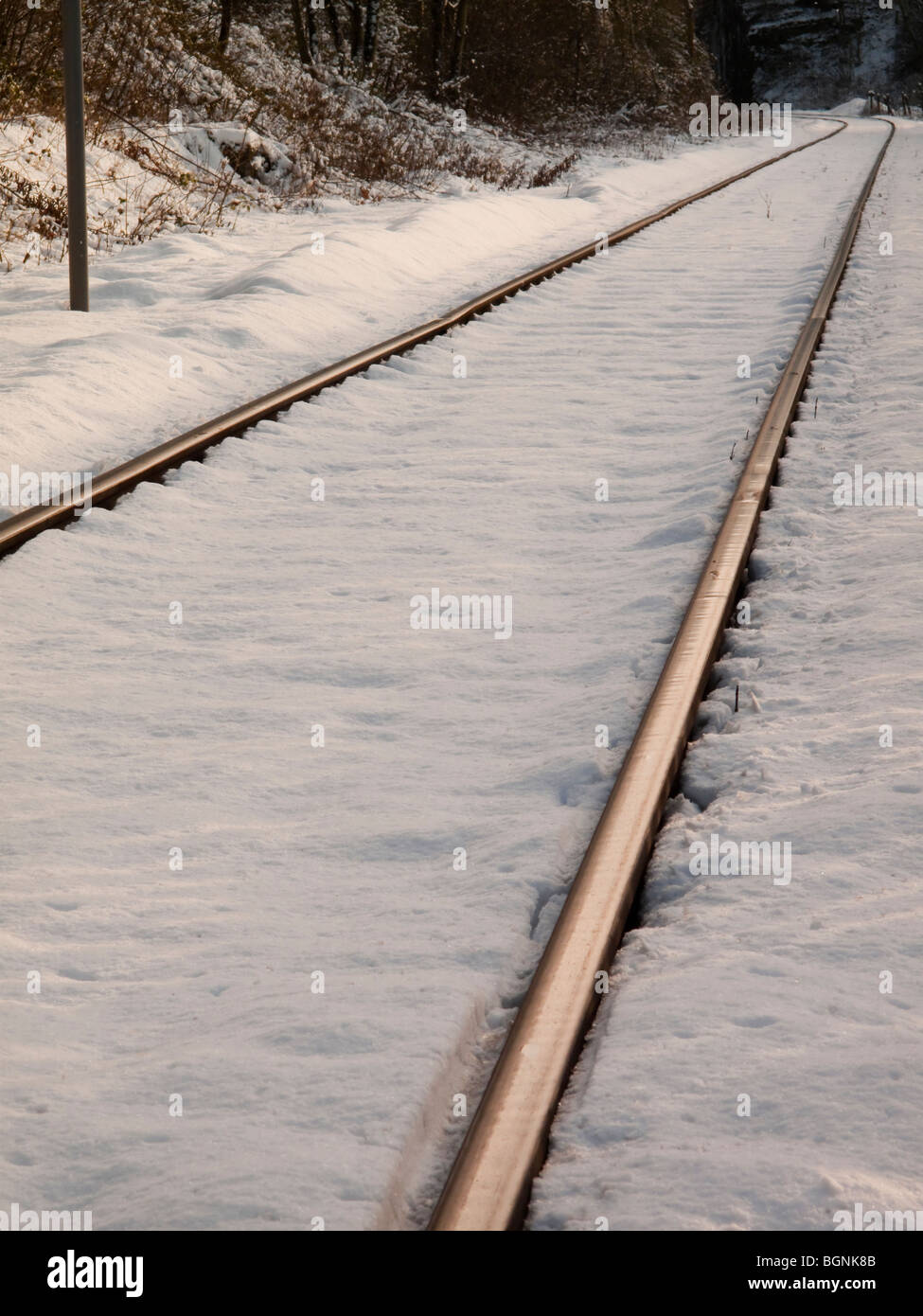 Single track railway line covered in snow with the rails visible Stock ...