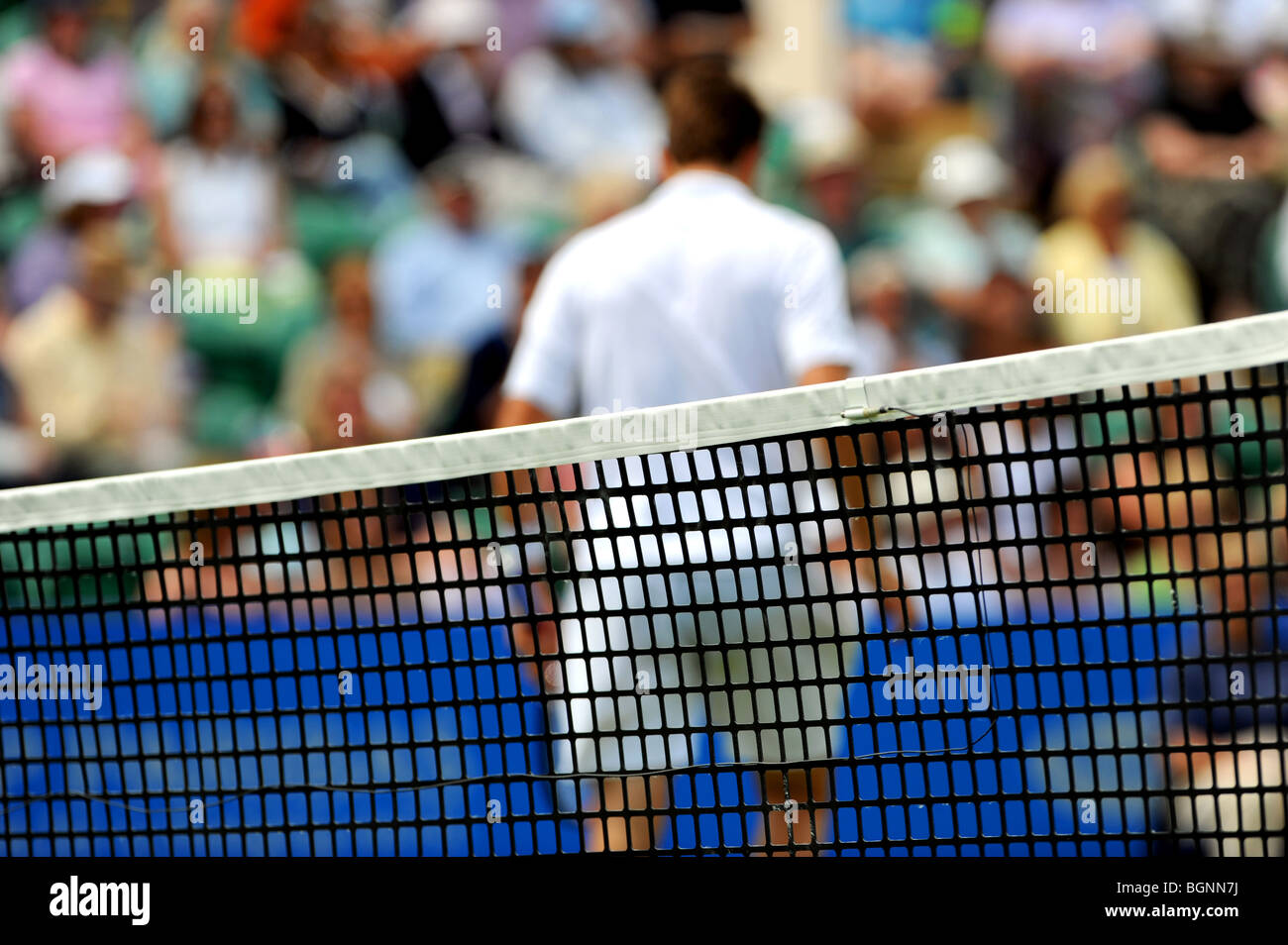 Tennis player walks away from the net after losing a point Stock Photo ...