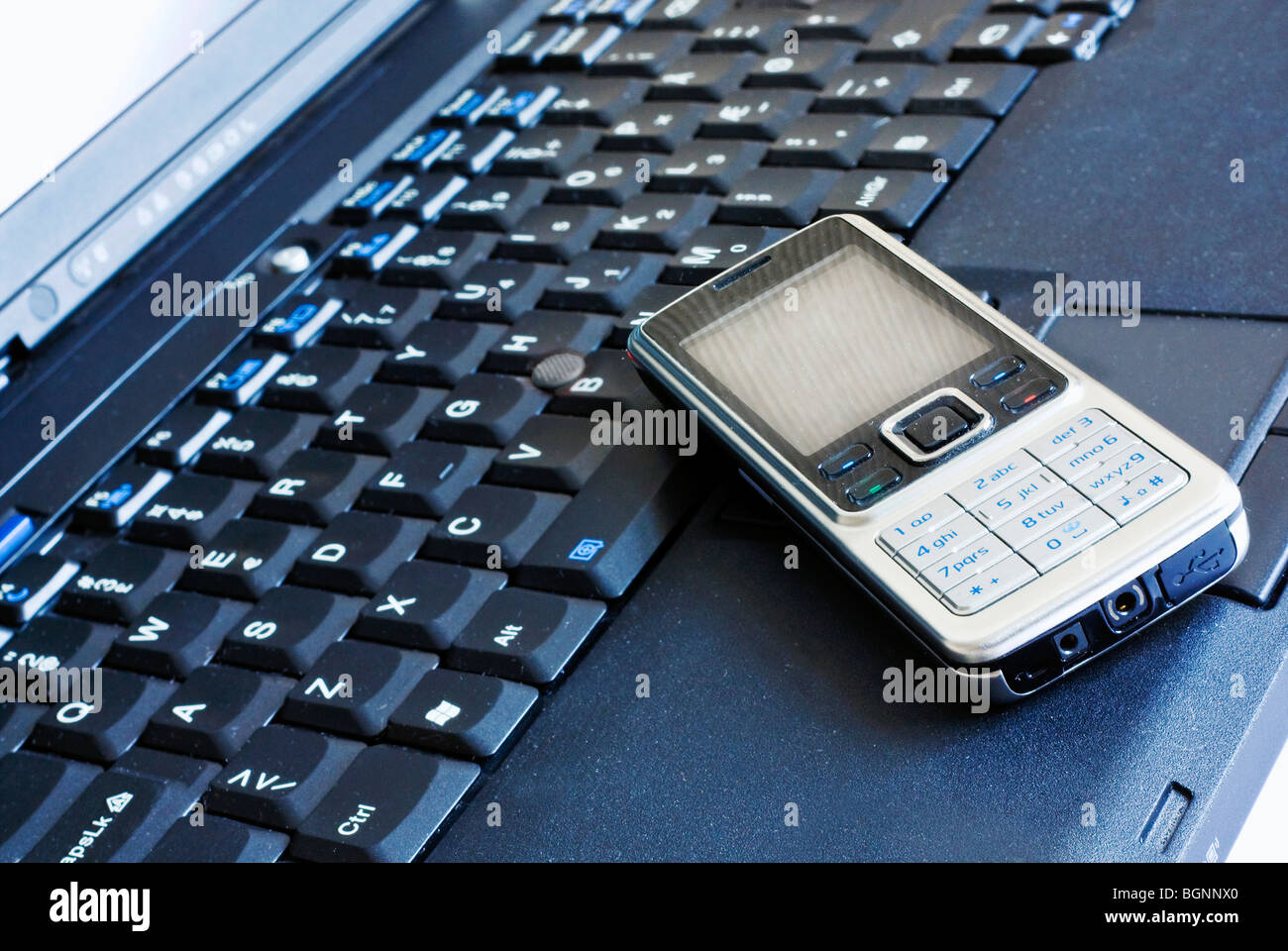 Laptop and cell phone Stock Photo - Alamy