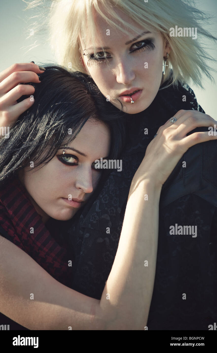 Two goth women concept portrait. Soft yellow and blue tint Stock Photo ...